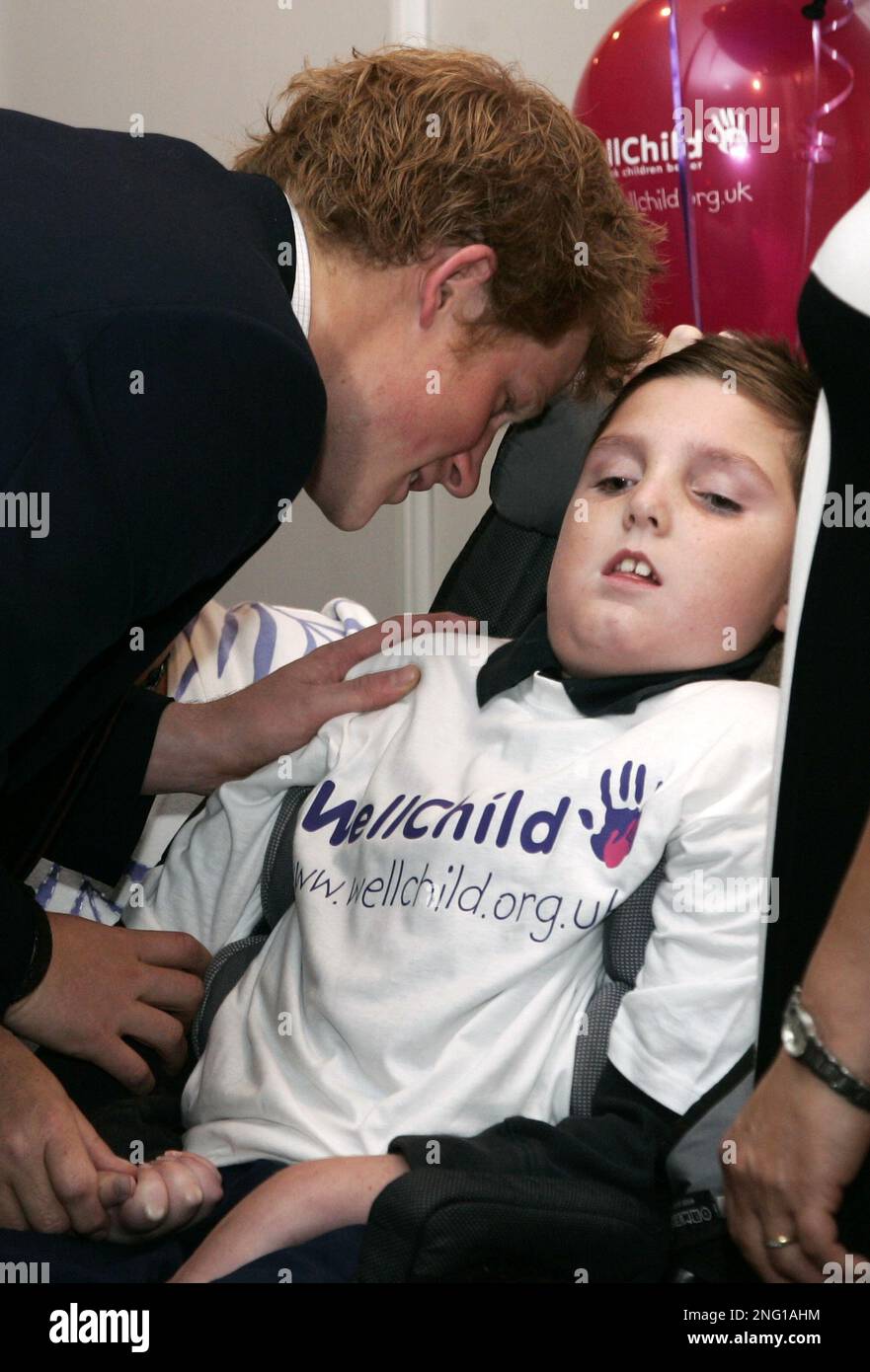 Britain's Prince Harry, left, talks with Ben Pickering, right, who ...