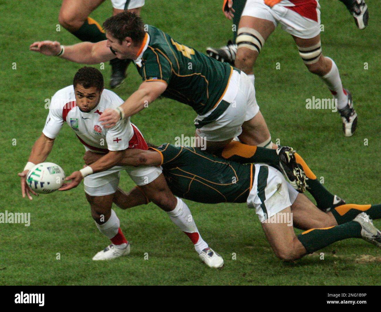 England fullback Jason Robinson is tackled by South African players ...