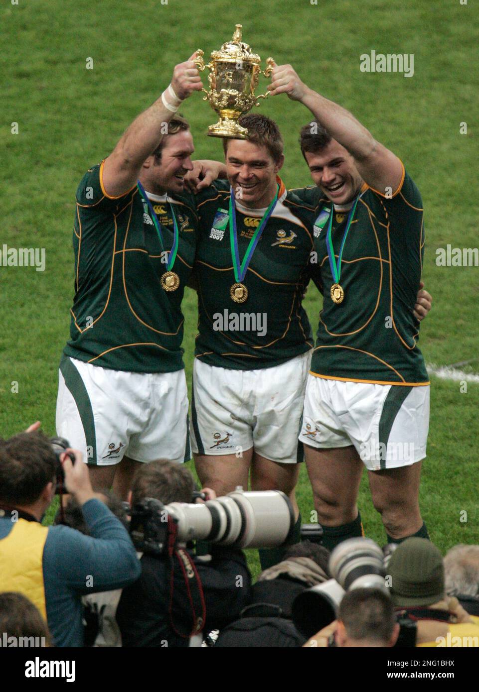 South African player John Smit, center, and other players hold the cup ...