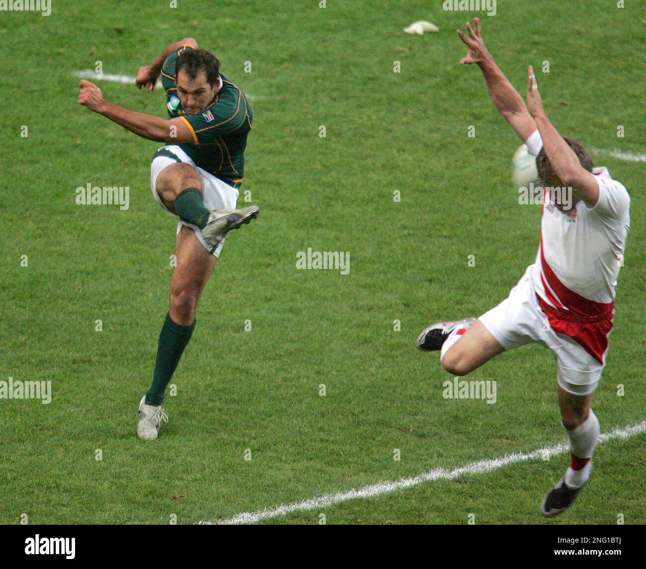 England's Mark Cueto, right, charges down a kick from South Africa's ...