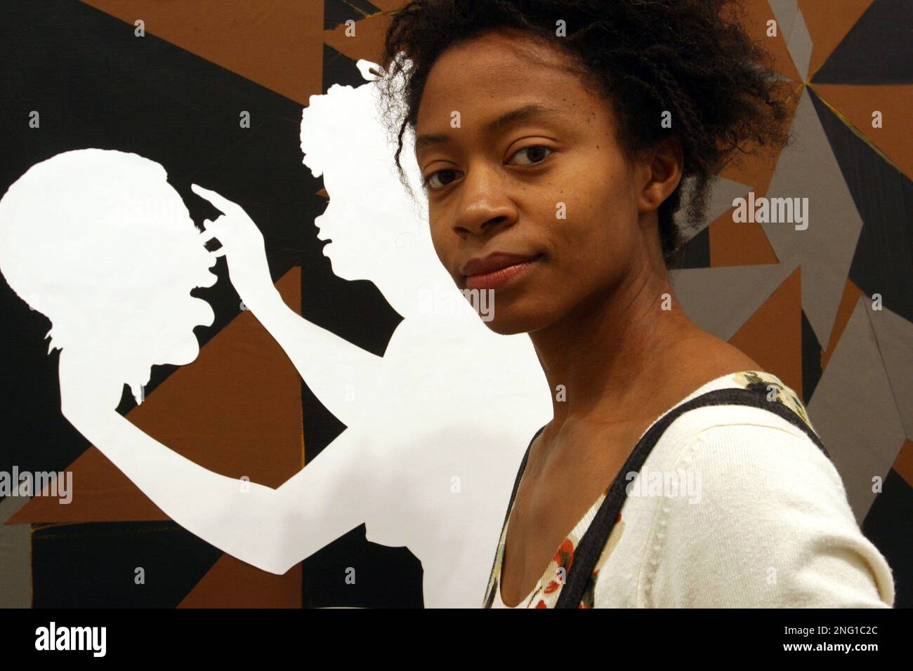 Artist Kara Walker poses for a photograph in front of one of her pieces ...