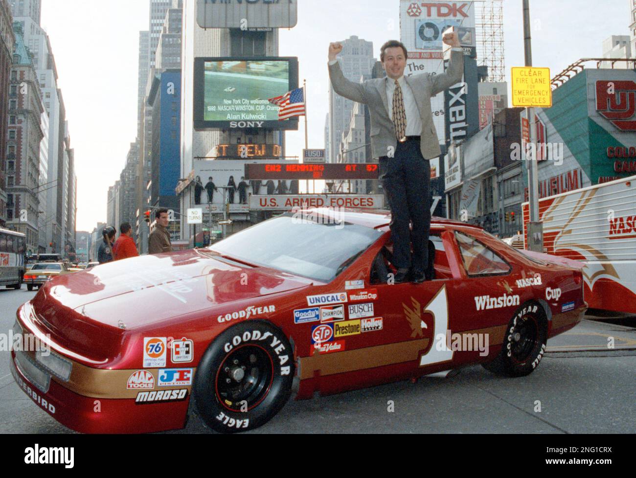 Race car Alan Kulwicki stands on his car in New York's Times Square ...
