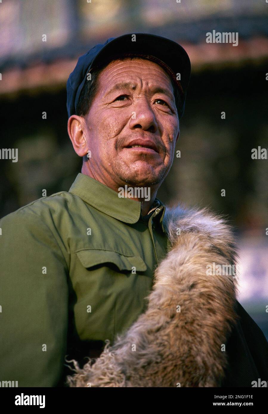 A man poses at Beijing's Temple of Heaven at sunset, December 1, 1984 ...