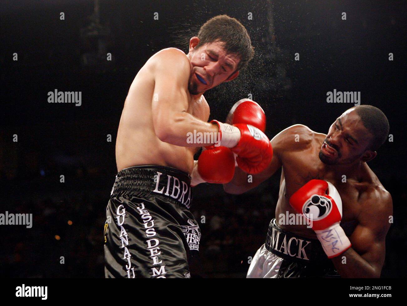 Librado Andrade, left, takes a right hand from Yusaf Mack, during their ...