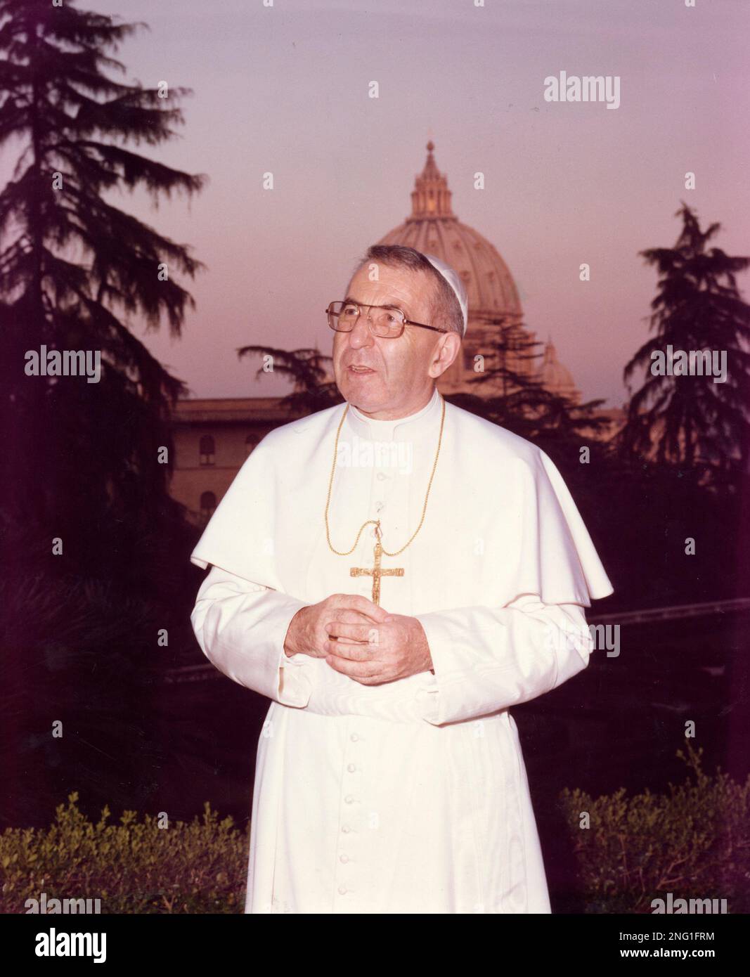 Pope John Paul I in white gown clasping hands smiling as he walks in ...