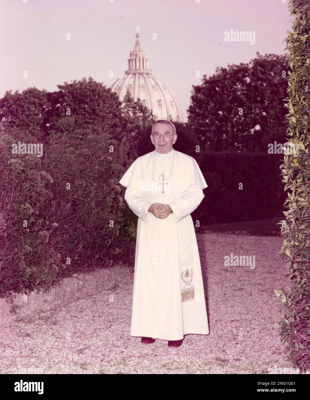 Pope John Paul I in white gown clasping hands smiling as he walks in ...