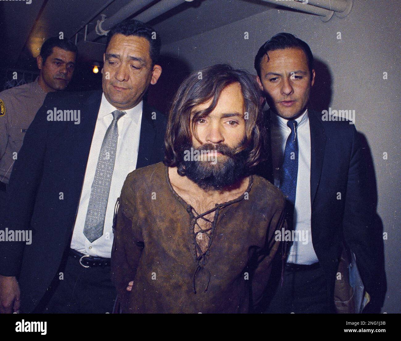 Charles Manson is escorted to his arraignment on conspiracy-murder ...