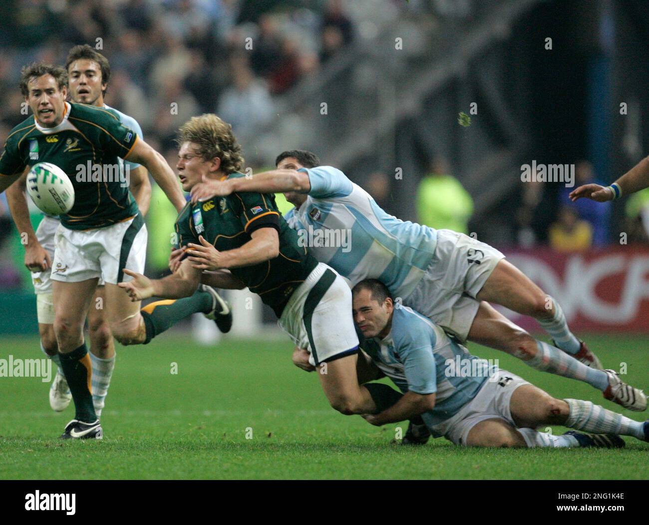 South Africa's Francois Steyn, center is tackled by Argentinian players ...