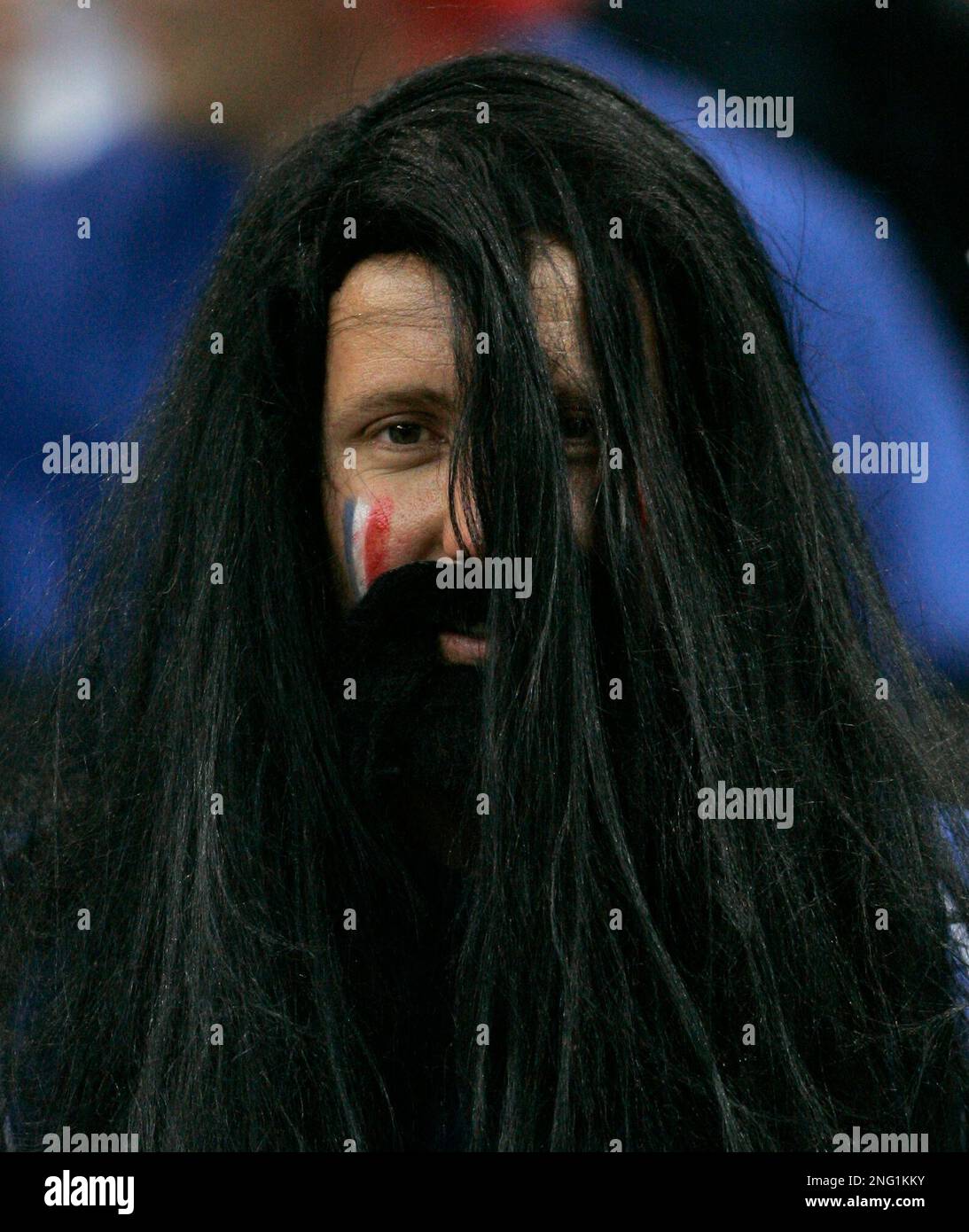 A French supporter wearing a wig to look like player Sebastien Chabal ...