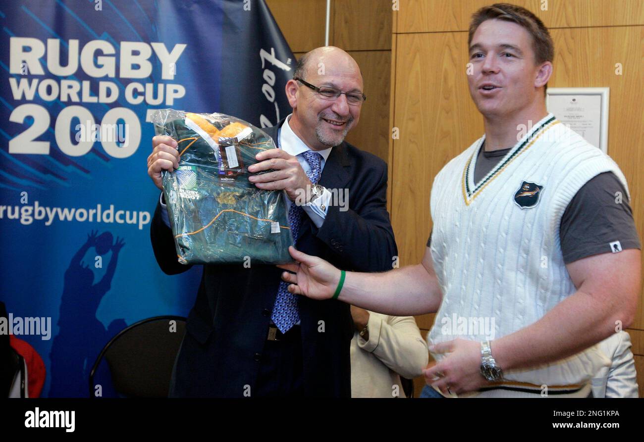 South Africa rugby team captain John Smit, right, gives a Springboks ...