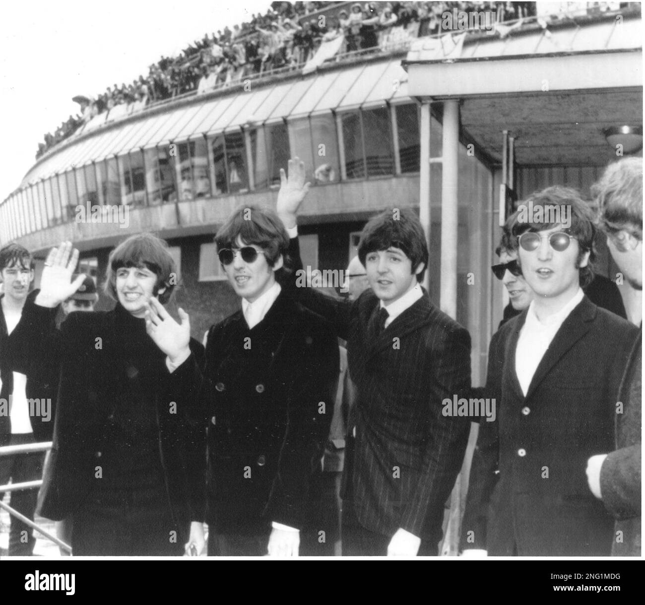The Beatles wave to a crowd at London Airport as they prepare to take ...
