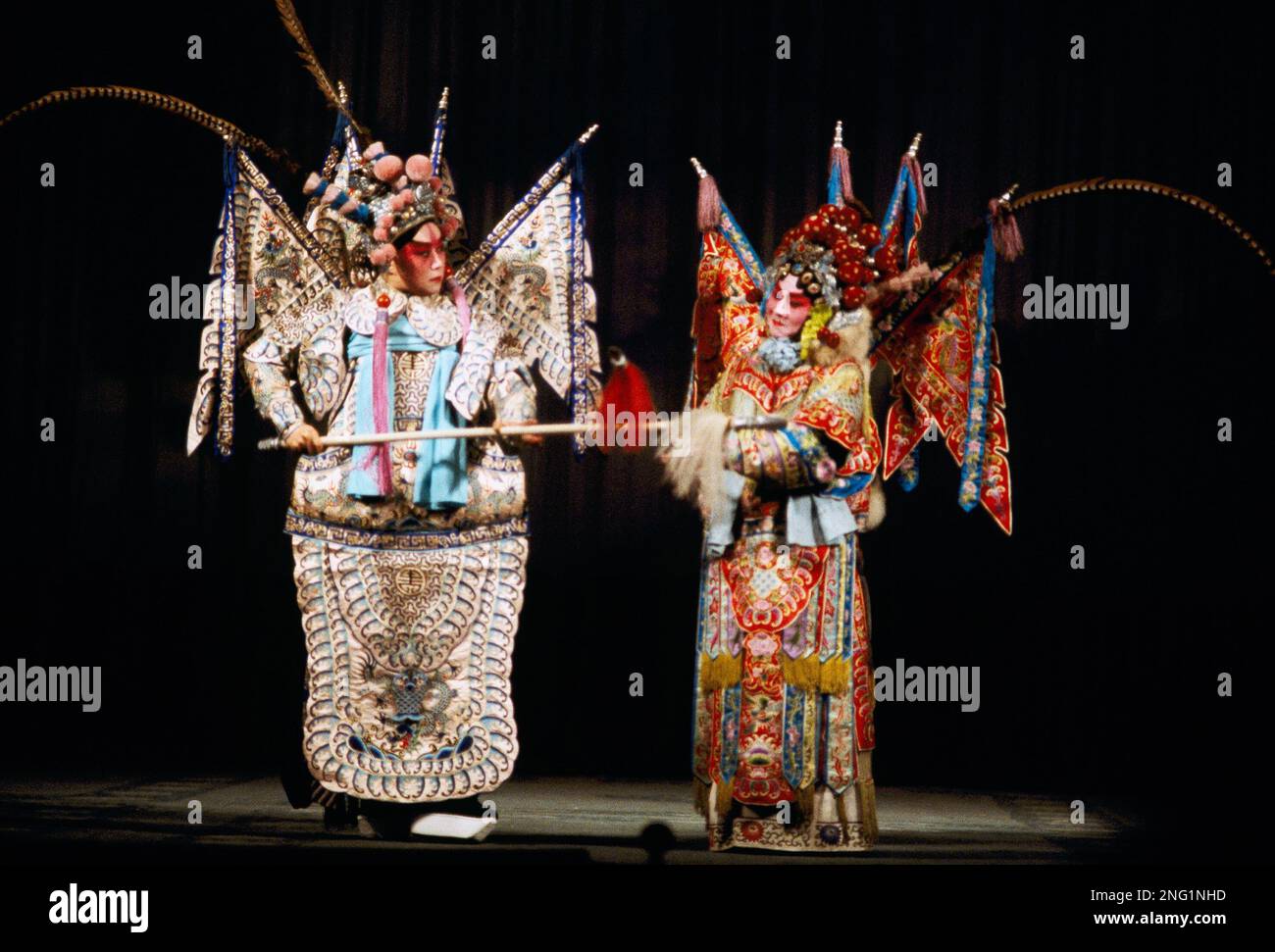 Chinese actors in elaborate traditional costumes during a performance ...