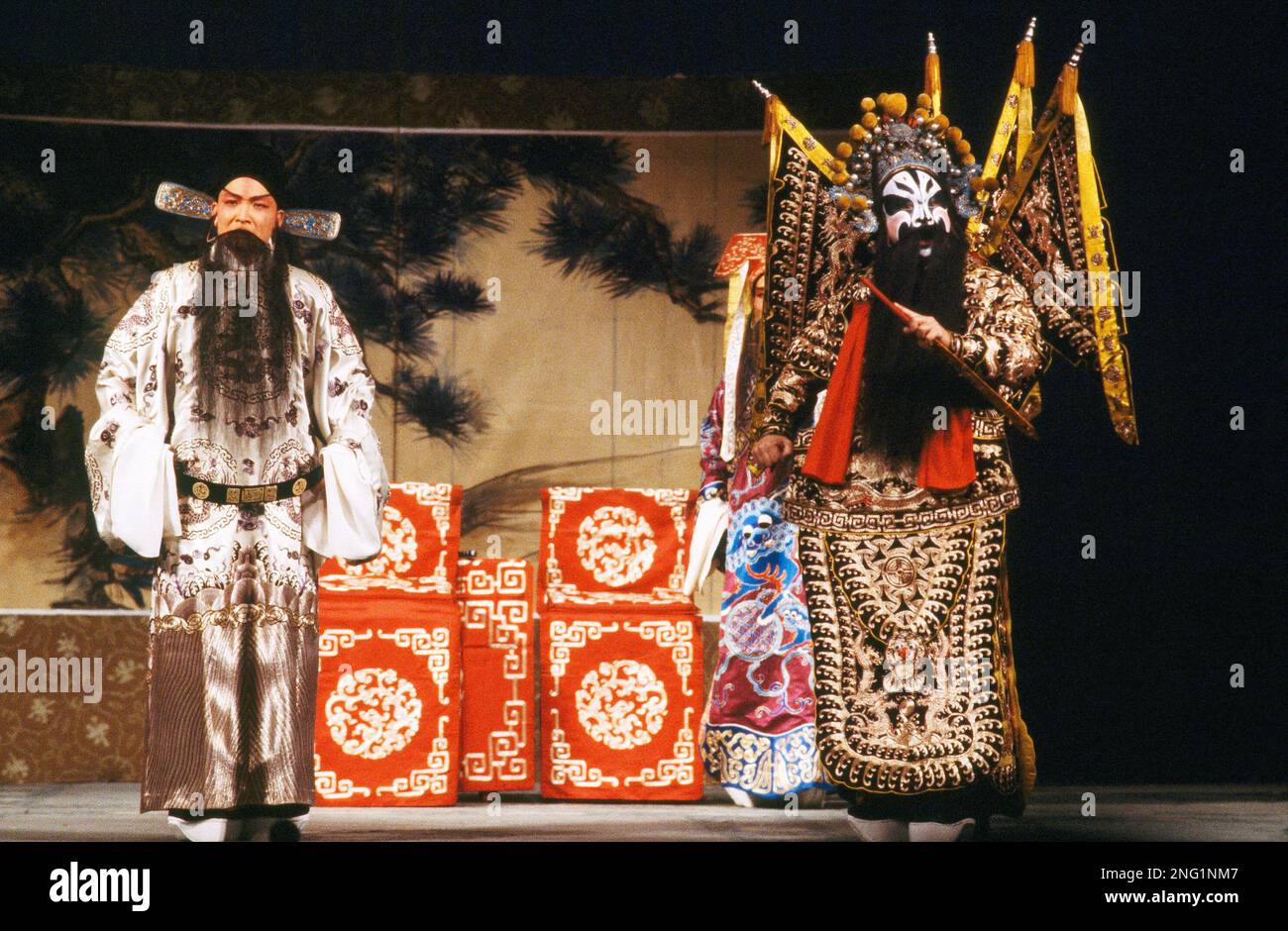 Chinese actors in elaborate traditional costumes during a performance ...