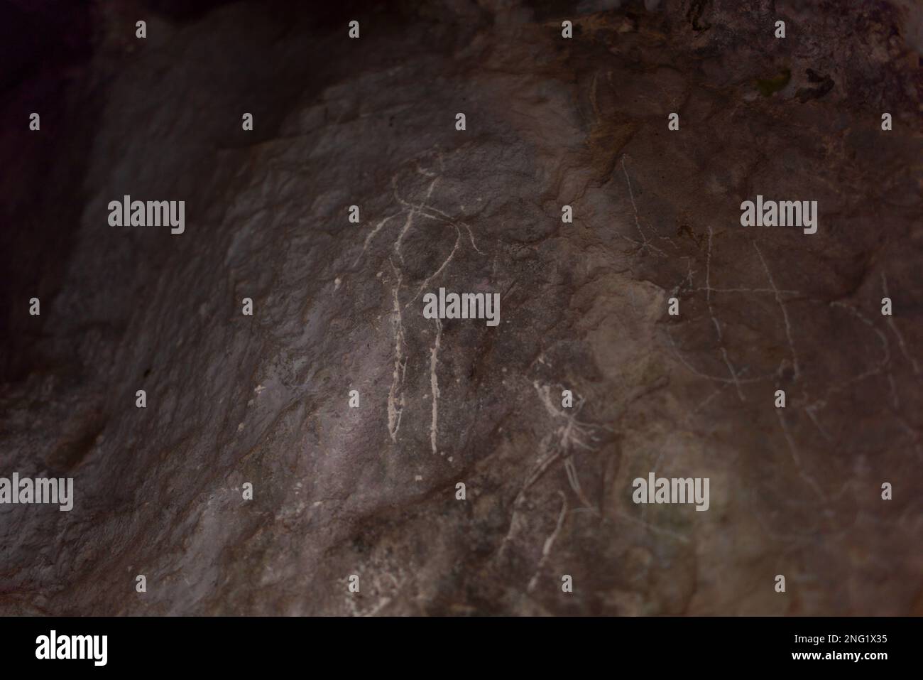 Rock drawing of ancient people petroglyph on the wall of the cave of ...