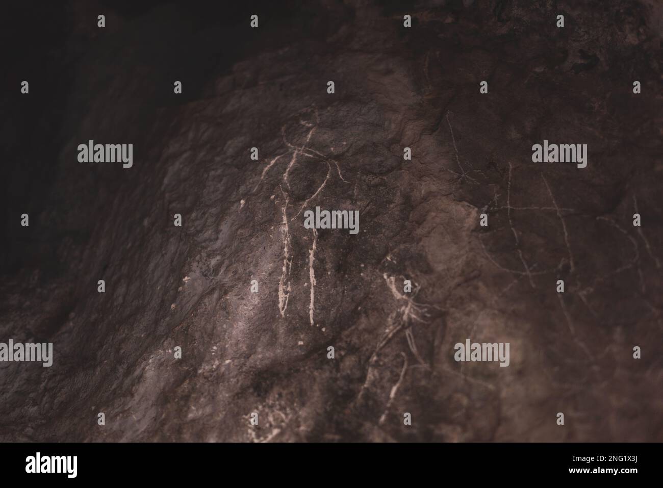 Rock drawing of ancient people petroglyph on the wall of a cave in the ...