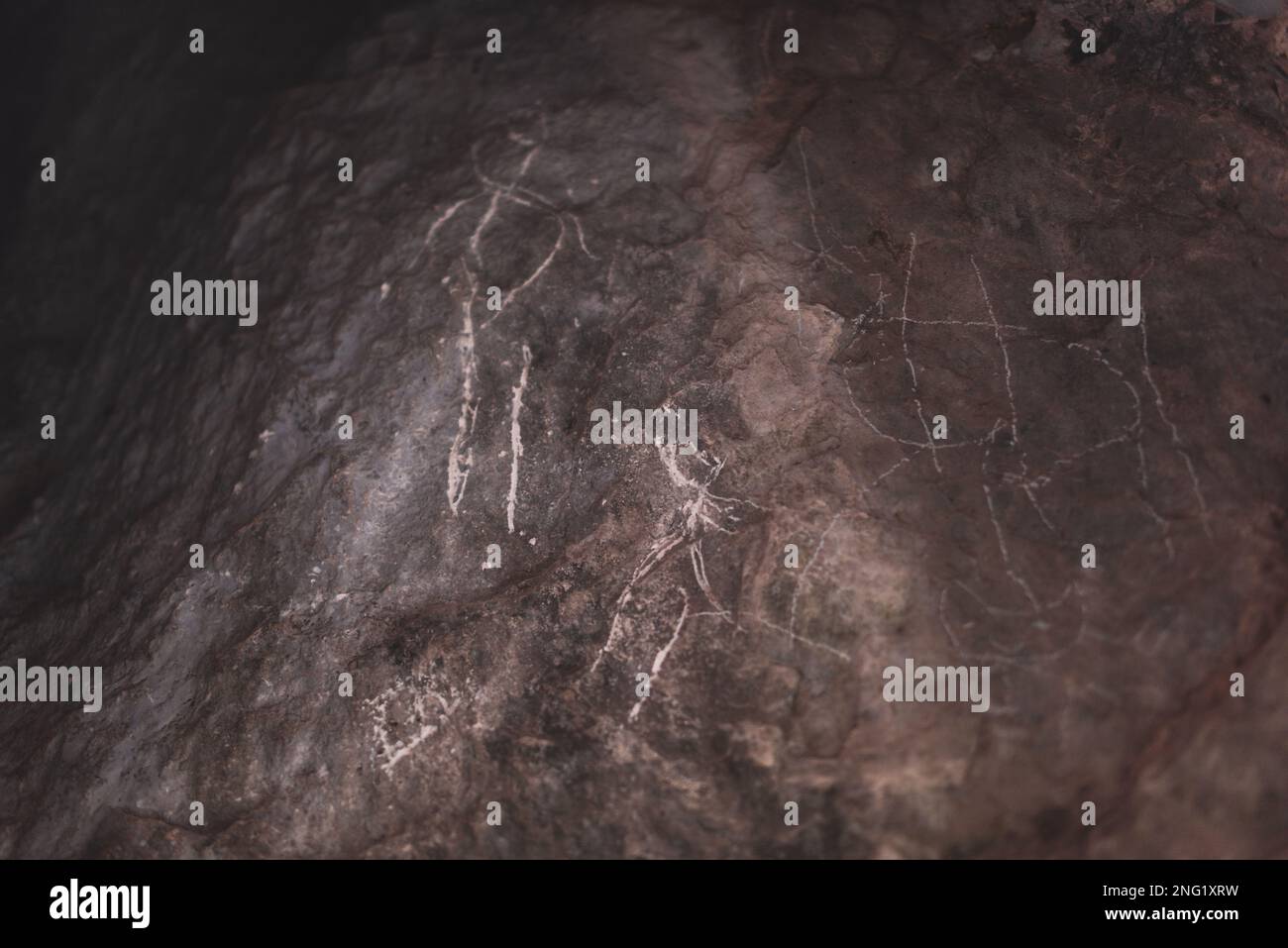 Rock drawing of ancient people petroglyph on the wall of a cave in the ...