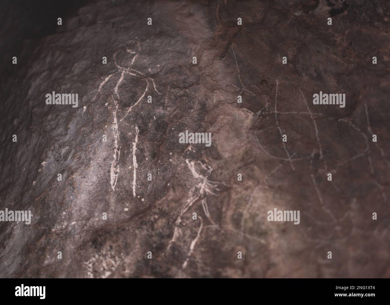 Rock drawing of ancient people petroglyph on the wall of a cave in the ...