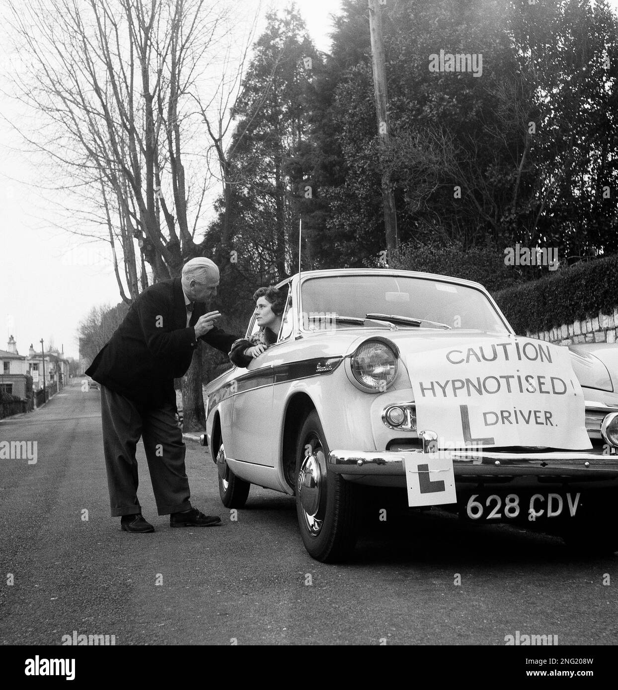 Hypnotist Henry Blythe, gives his daughter Sally, 17, advice before she ...