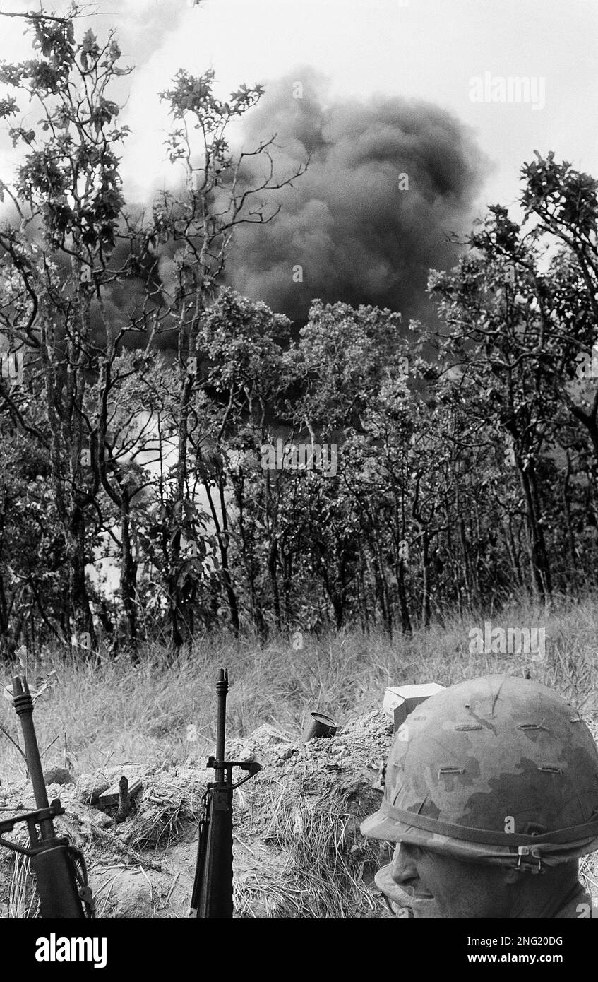 American soldier sits in forward trench position in South Vietnam's La ...