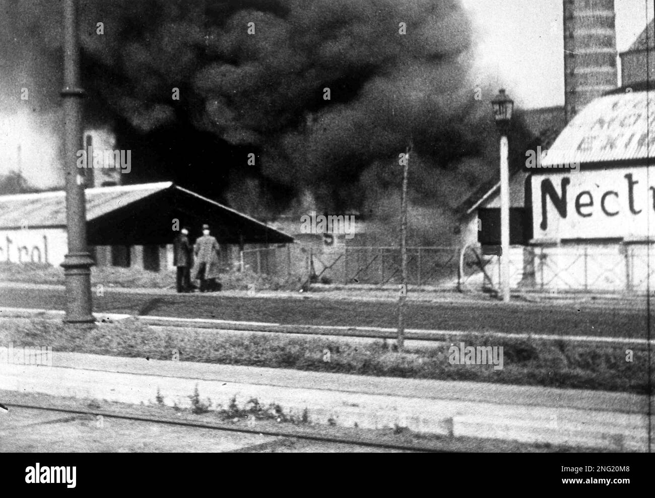 Thick columns of black smoke rise from a fire caused by a German ...
