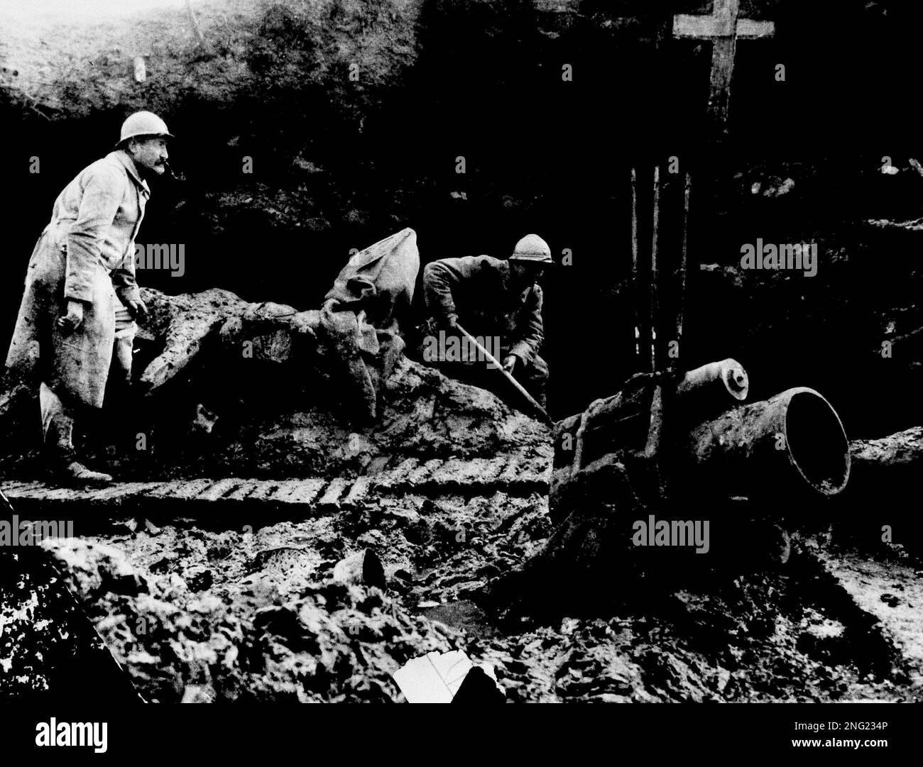 French soldiers discover a weathered mortar in a German trench during ...