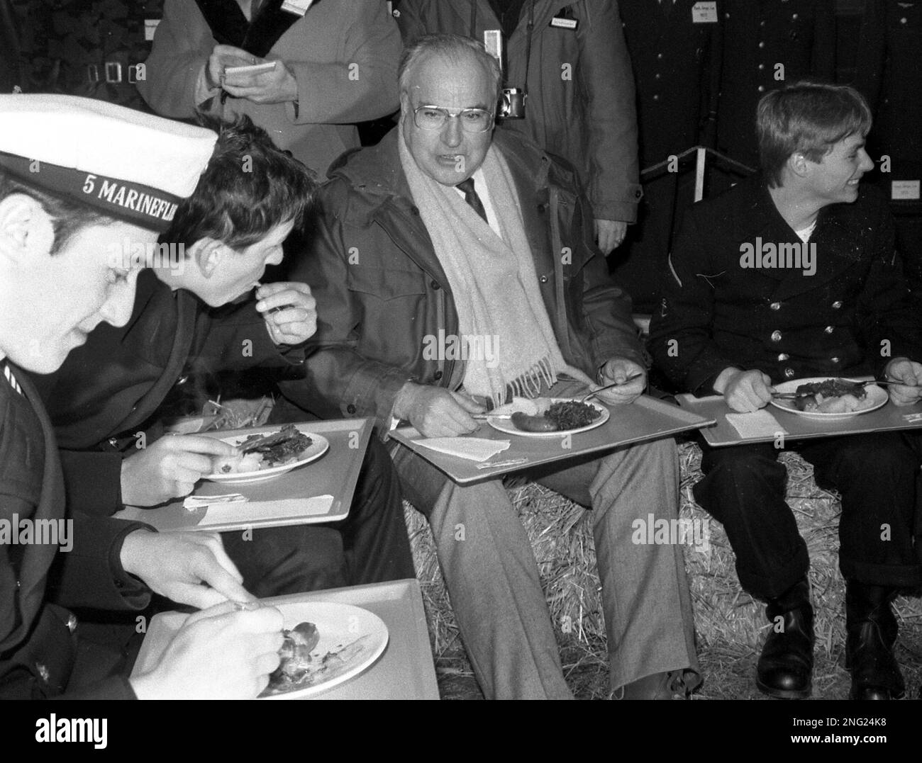 West German Chancellor Helmut Kohl, senter, sits amongst army pilots ...