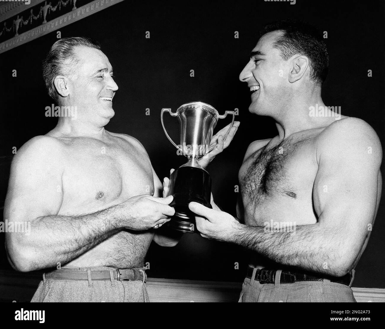 Antonio Rocca, an outstandin matman, receives the atlas trophy from its ...