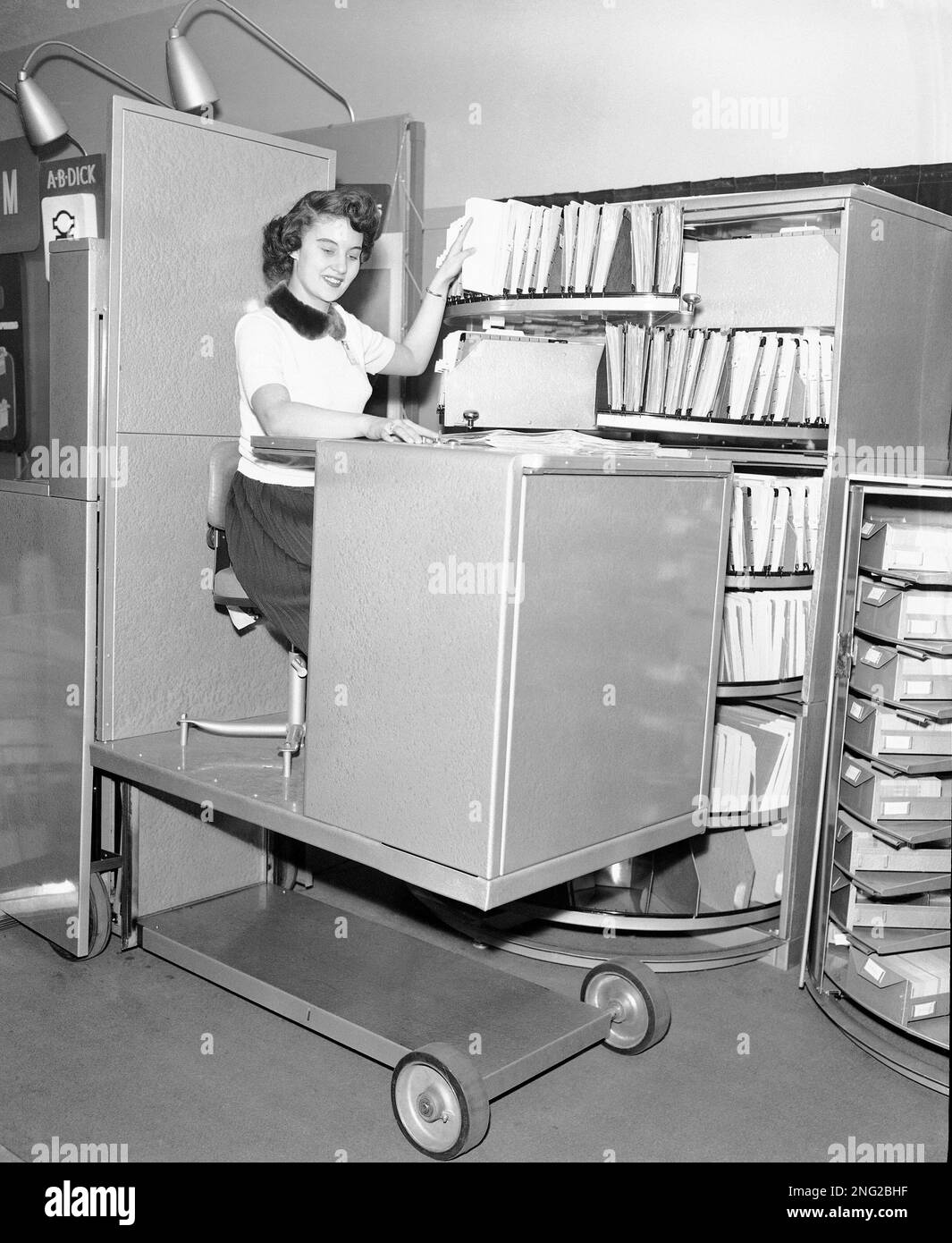 Jane Martin remains seated and "gets her filing done" using the ...