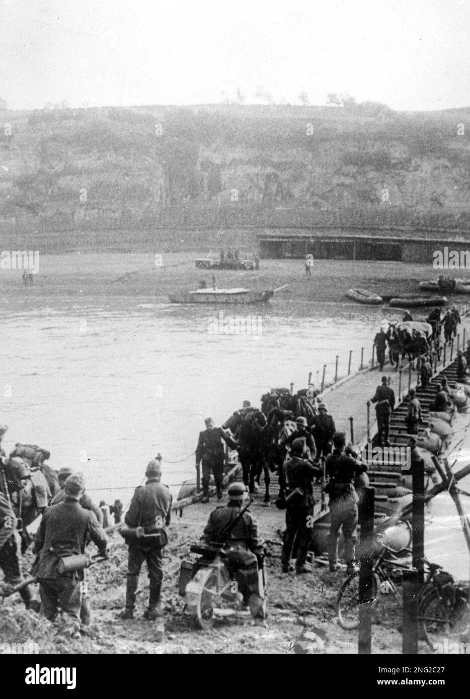 German troops cross a pontoon bridge of rubber boats as they advance ...
