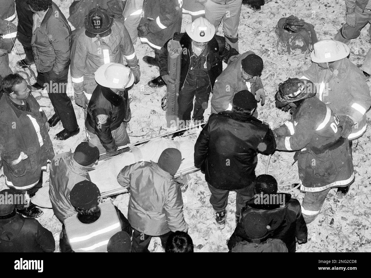 A victim of the Air Florida jetliner crash is strapped on to a ...