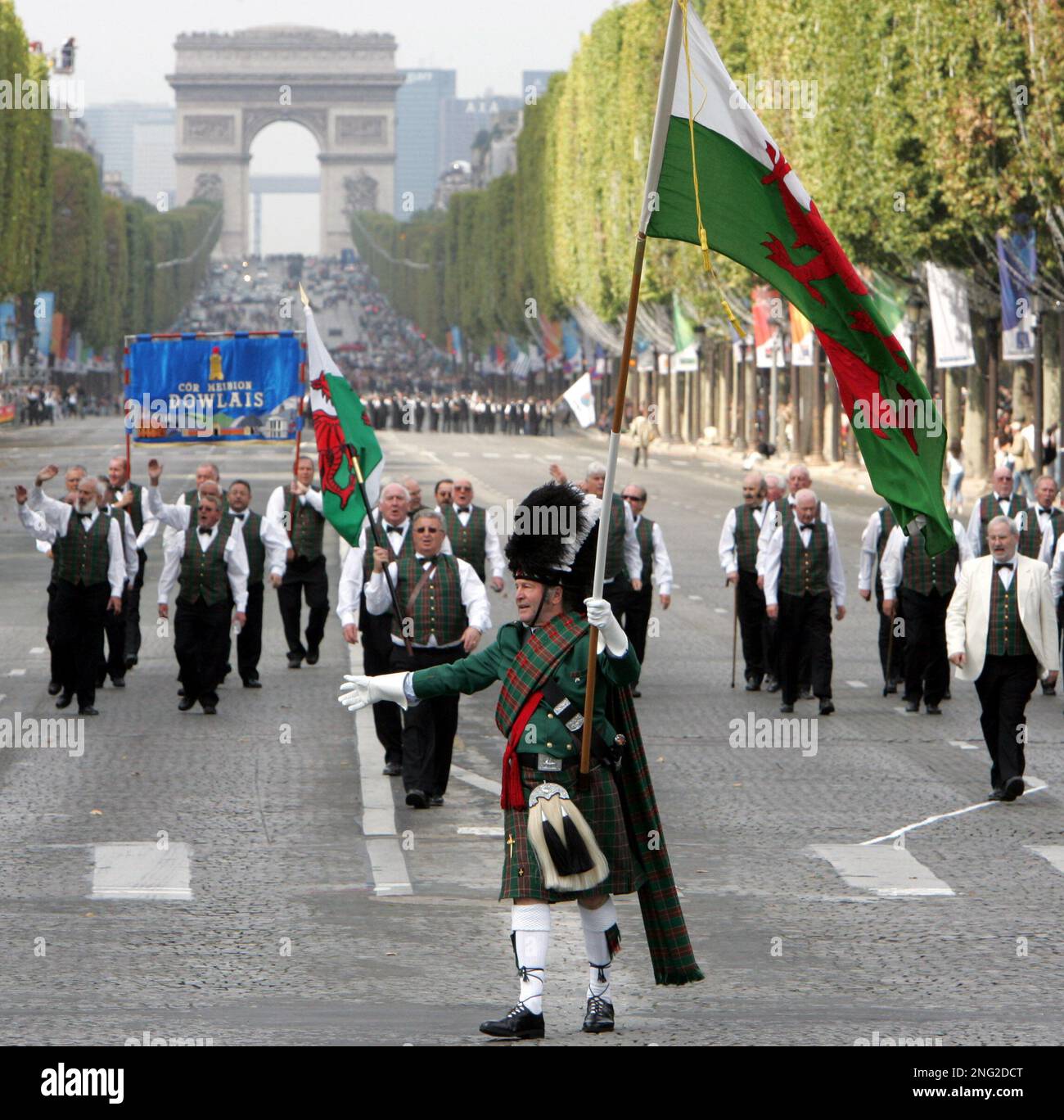 Welshmen wearing folk costumes walk down the Champs Elysees, as part of ...