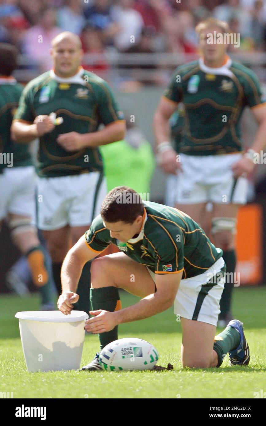 Andre Pretorius of South Africa takes sand fro a bucket as he prepares ...