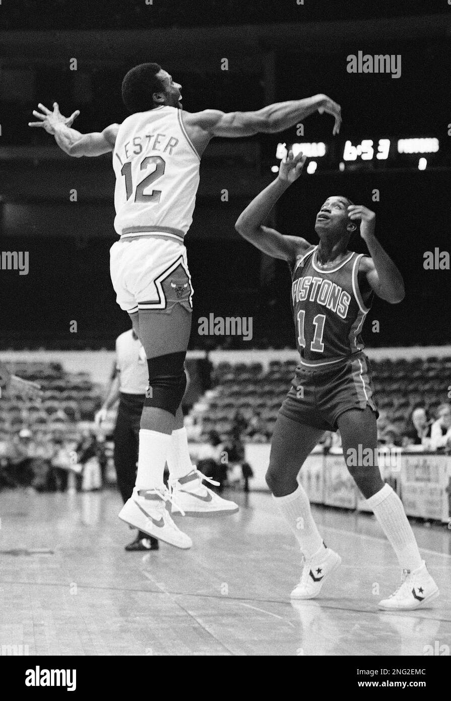 Detroit Pistons' Isiah Thomas, under the outstretched arms of Chicago ...