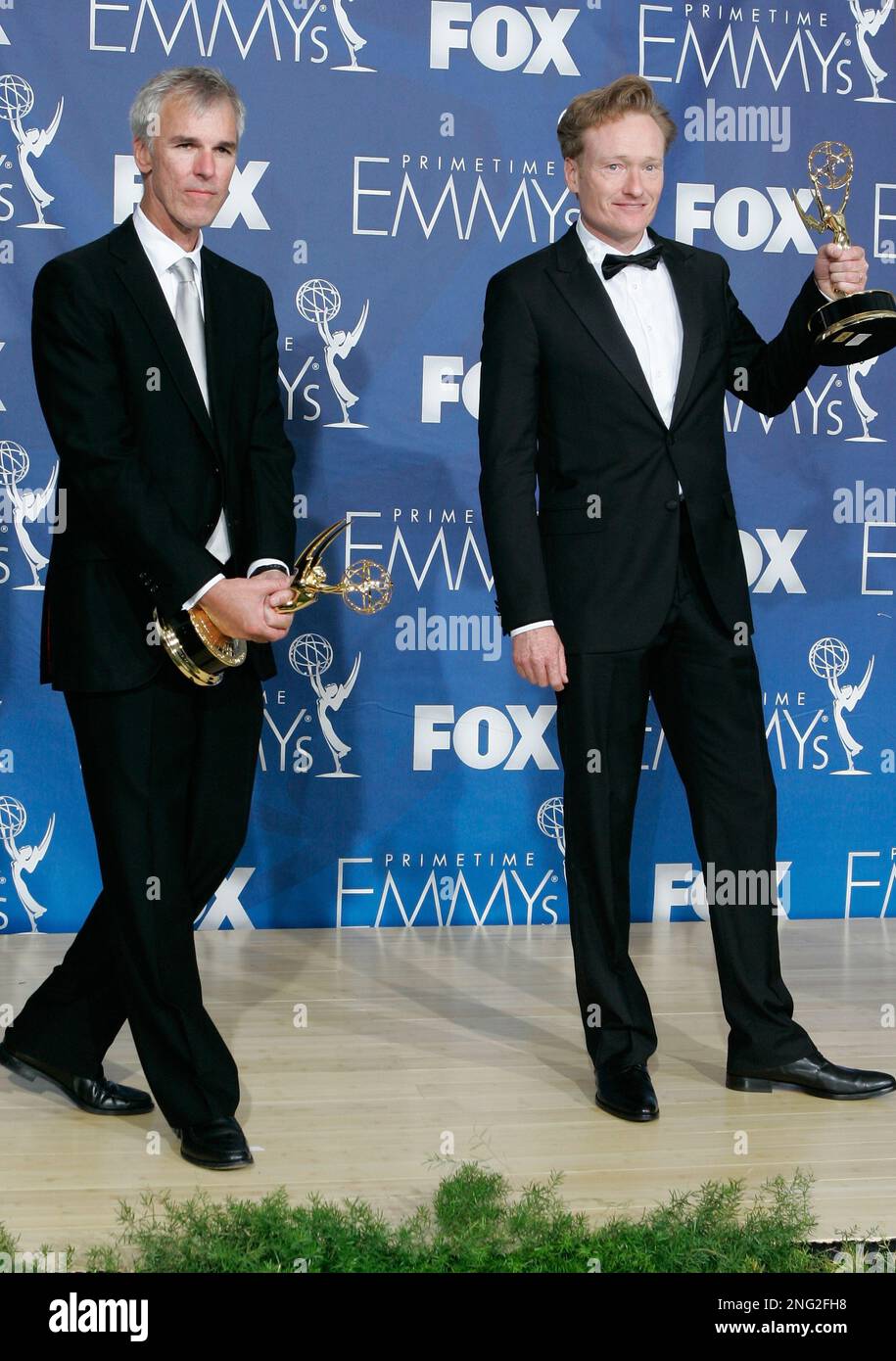 Head writer Mike Sweeney, left, and Conan O'Brien hold their awards for ...