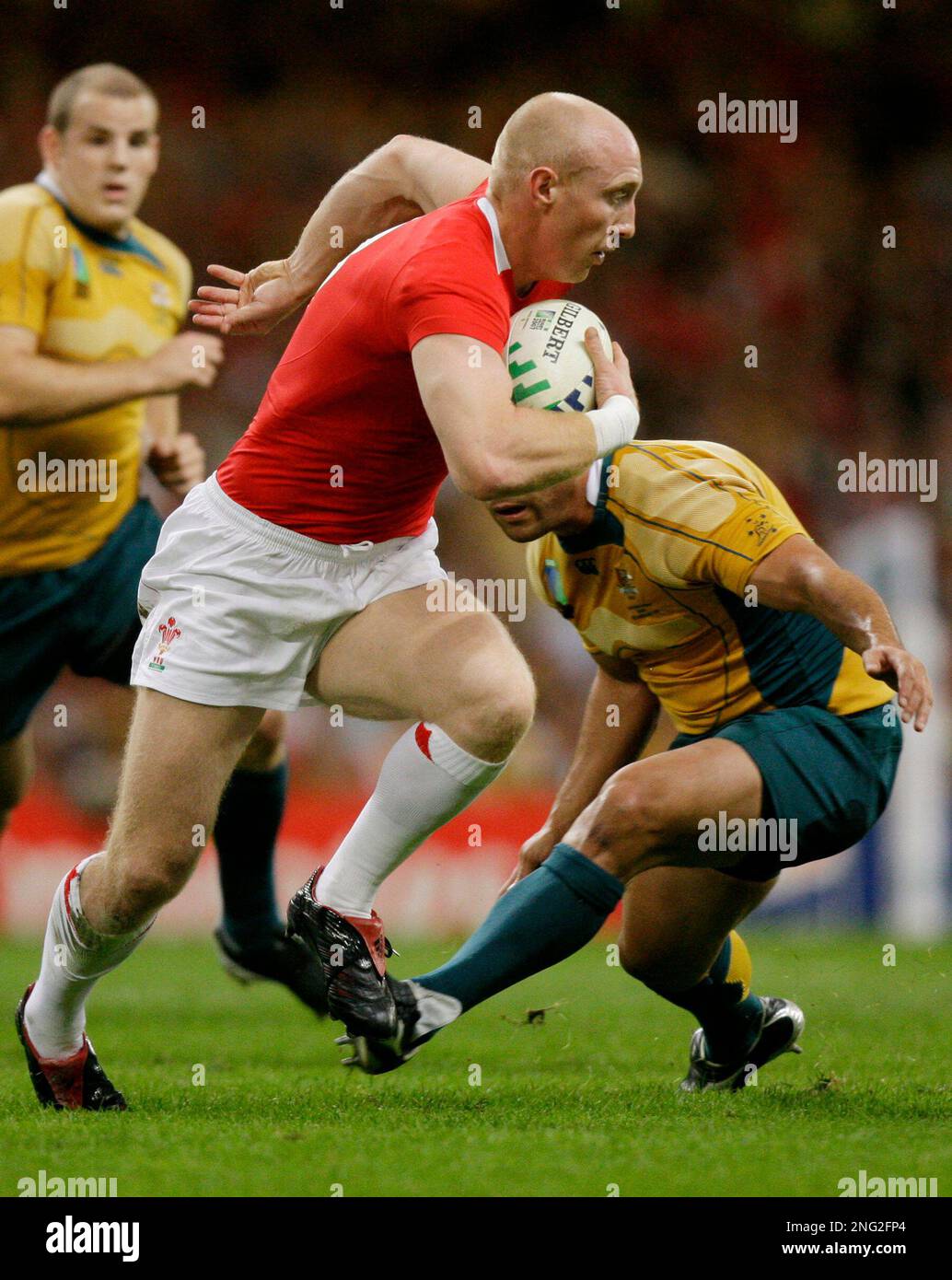 Wales center Tom Shanklin evades the tackle of Australia's George Smith ...