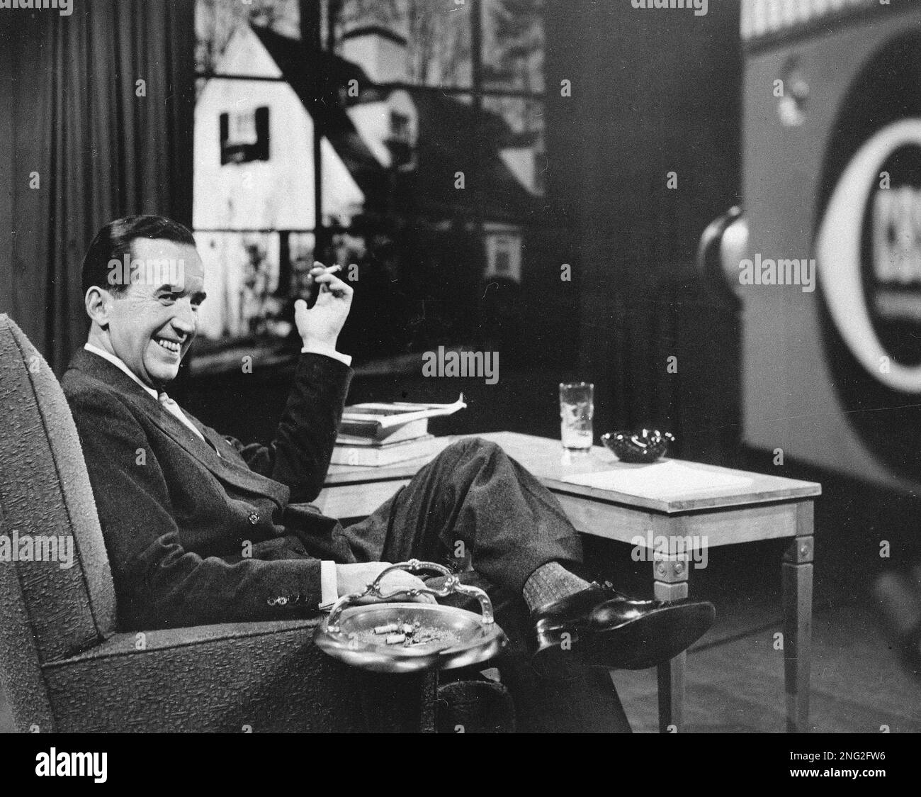 CBS News broadcaster Edward R. Murrow smokes a cigarette on a CBS set ...