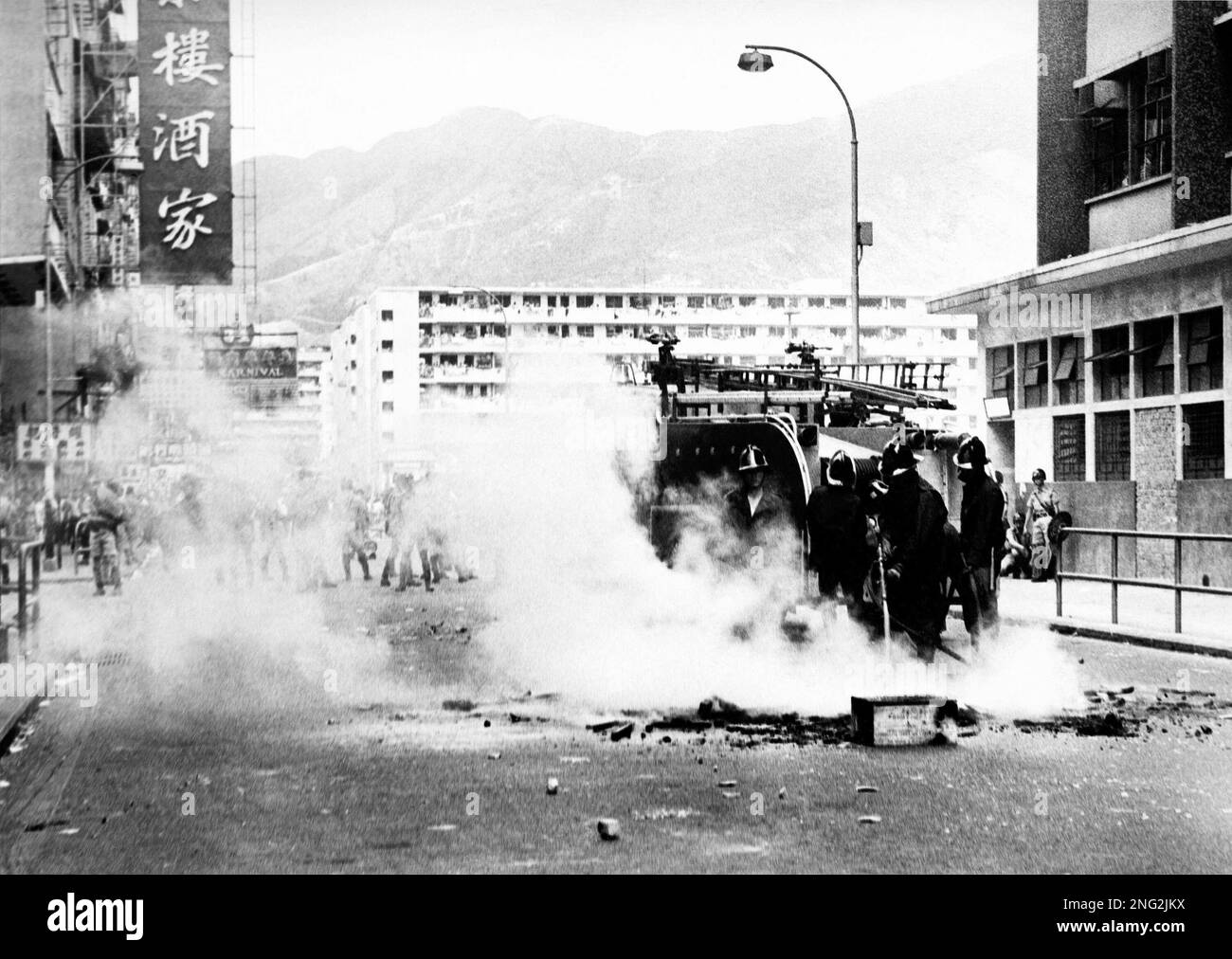 Firemen put out a rubbish blaze in street. Rioters in the Sanpokong ...