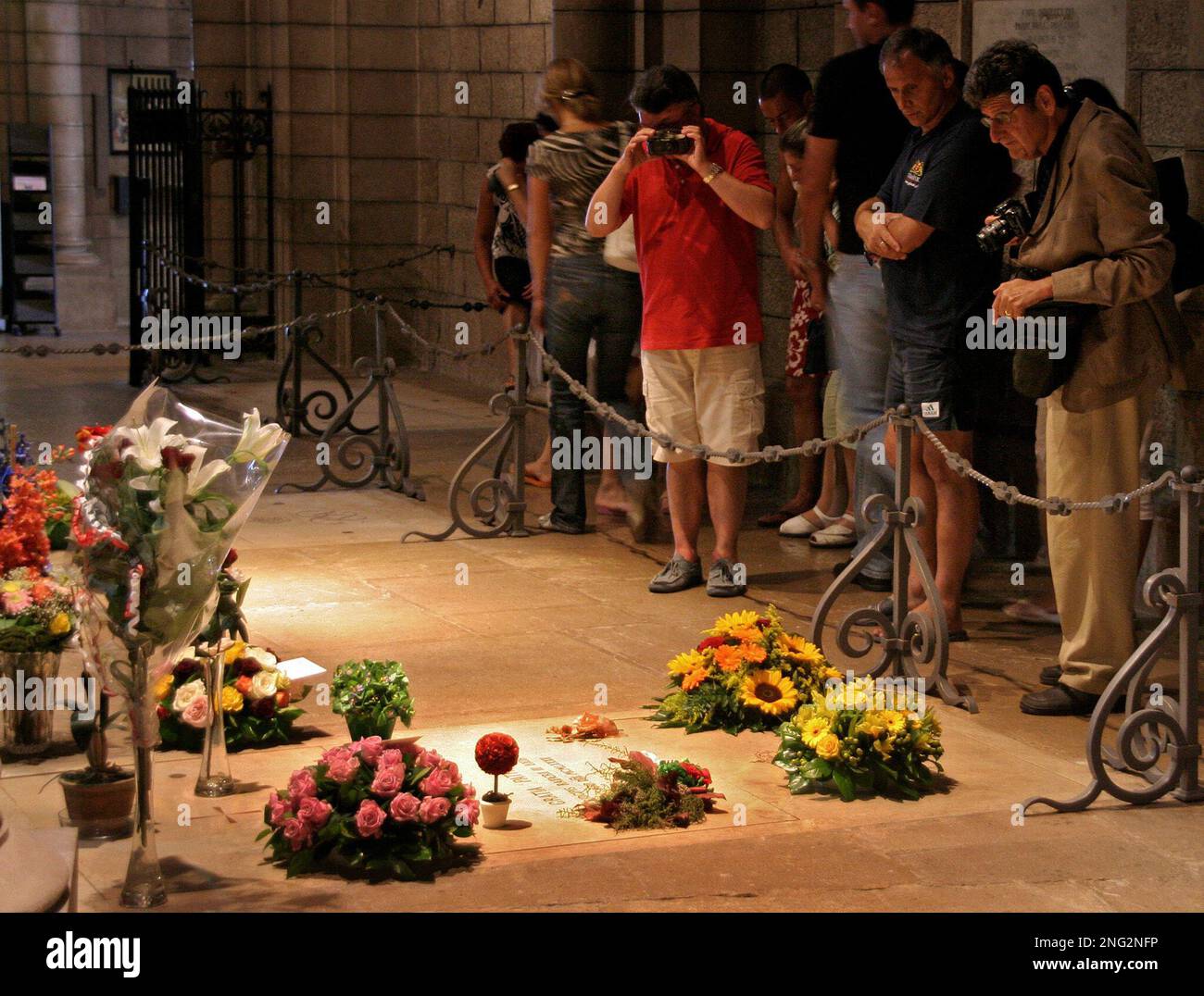 Visitors look at the grave of Princess Grace of Monaco, inside the ...