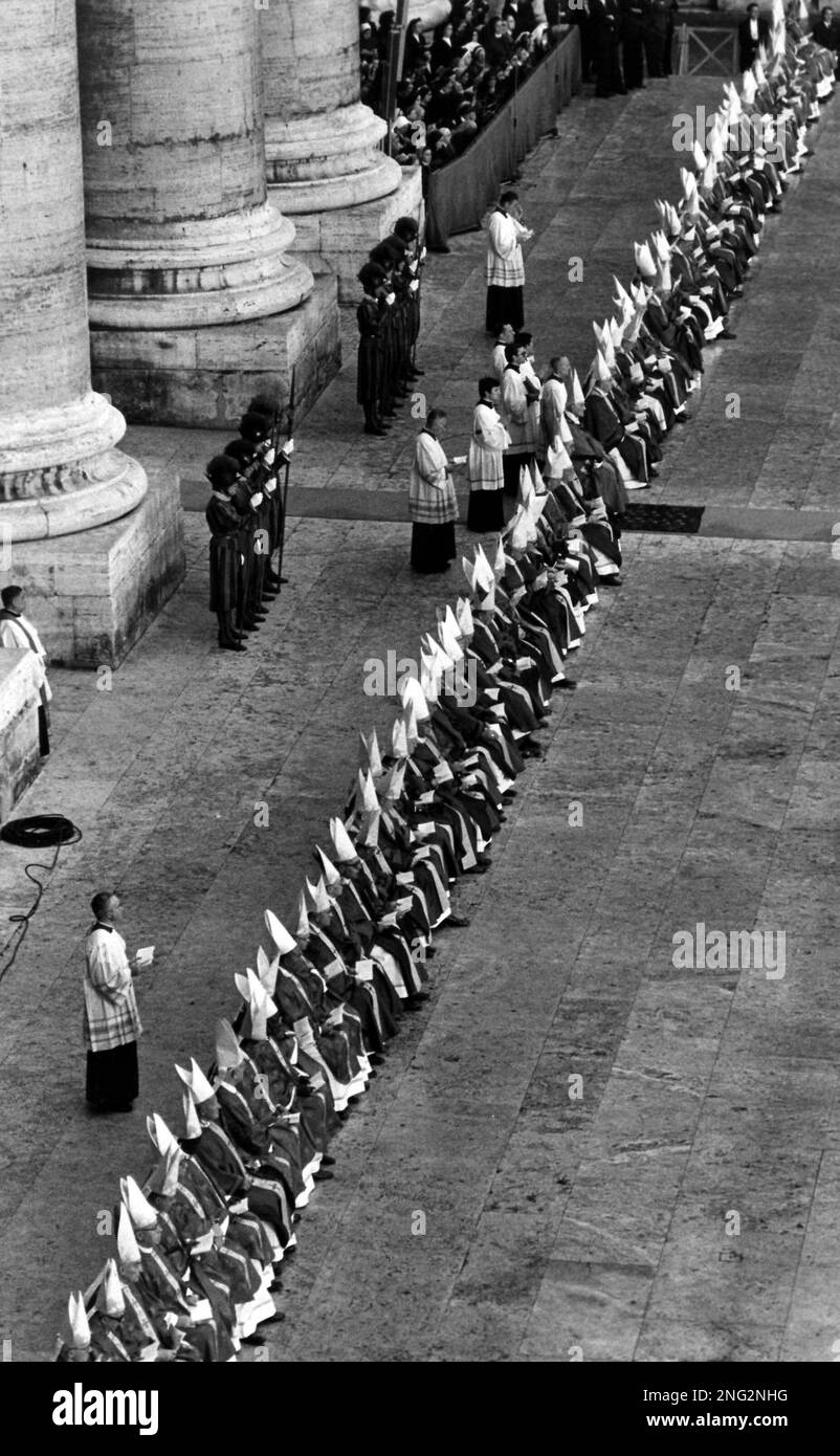 95 miter-wearing cardinals sit in a line outside the main entrance of ...