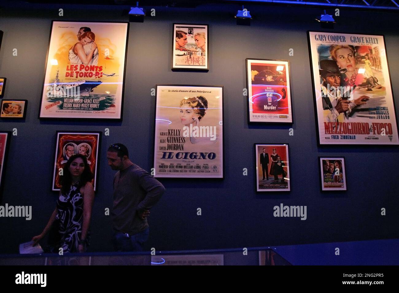 Visitors look at posters of Princess Grace's movies during the ...