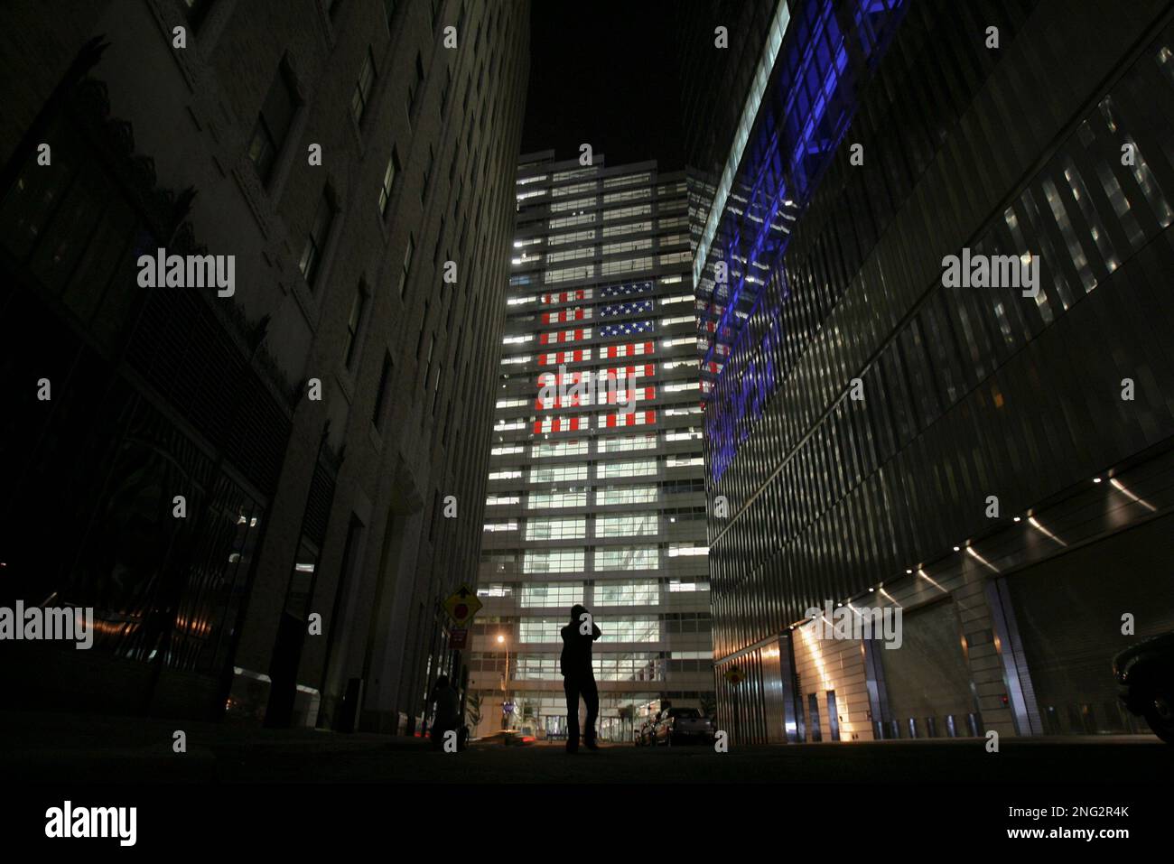 A man takes picture of the American flag at the World Trade Center site ...