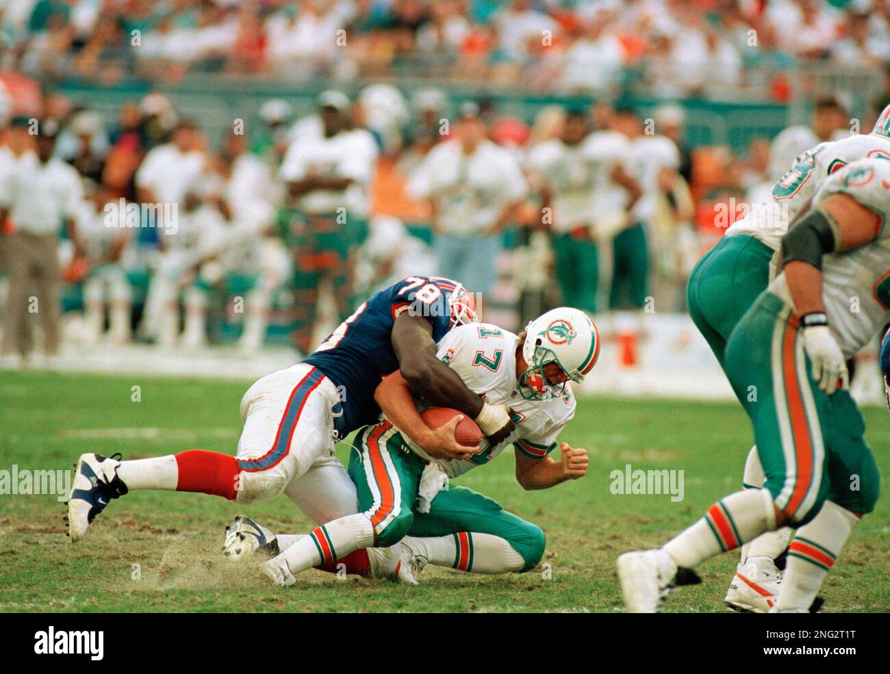 Miami Dolphin quarterback Steve DeBerg (17) is sacked by Buffalo Bill defensive end Bruce Smith ...