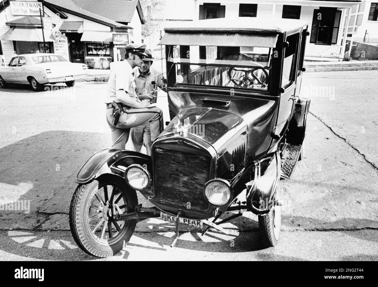 Police officers check the damage to the 1925 Model T Ford owned by ...
