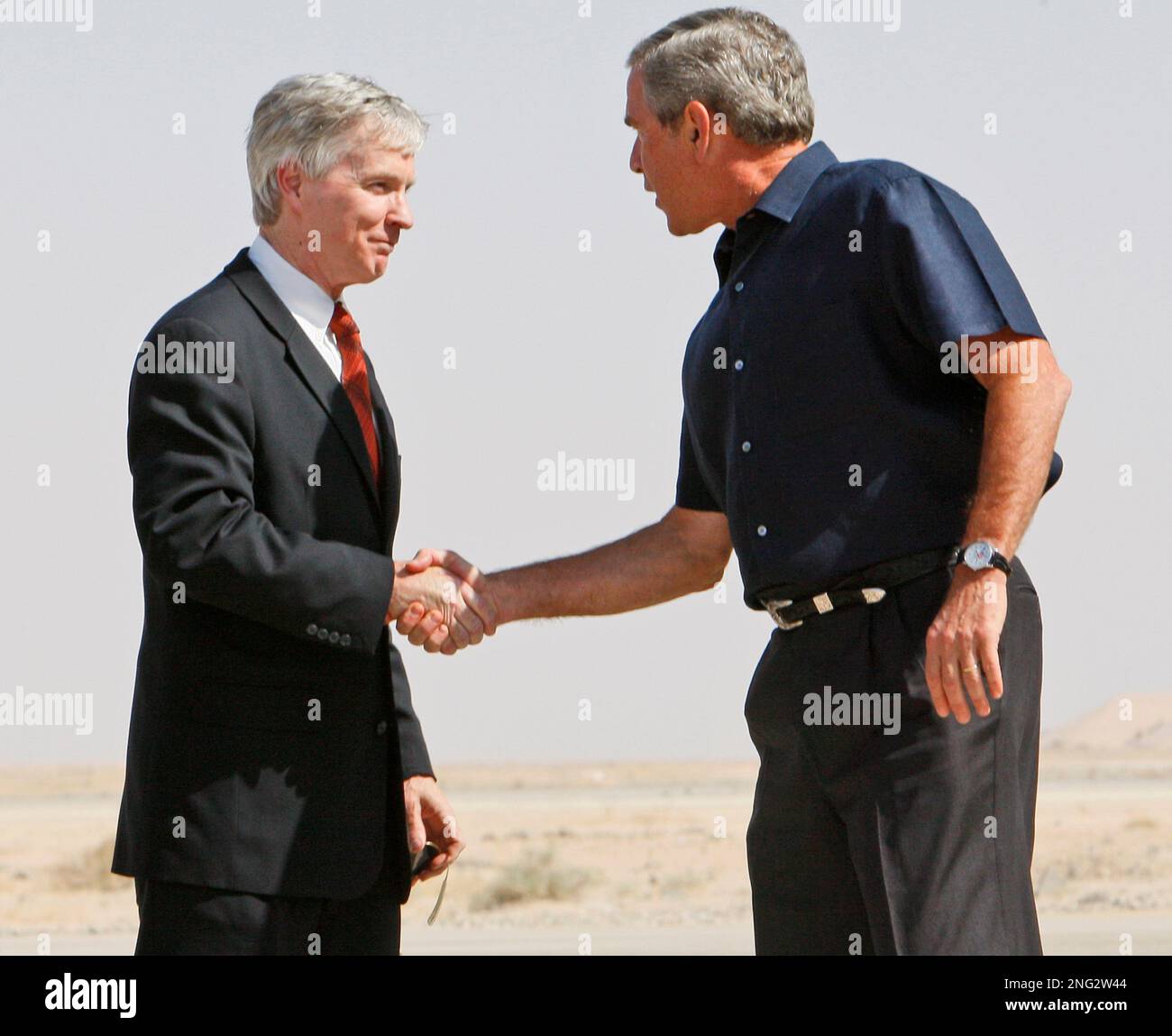 President Bush, right, is welcomed by U.S. Ambassador Ryan Crocker as ...