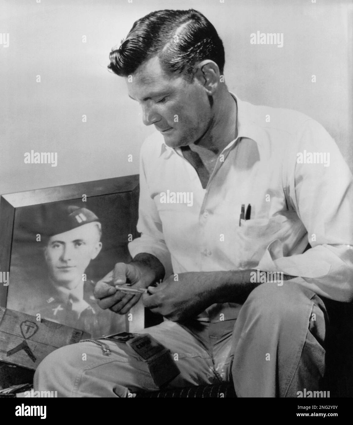 Ex- PFC Riley Tidwell shows souvenirs and picture of the late Capt ...