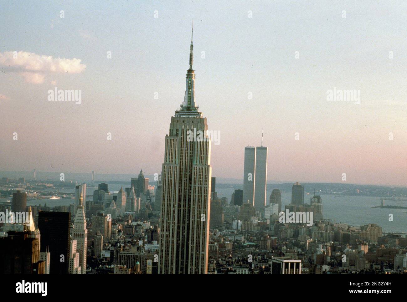 This is a view of the Empire State Building, foreground, with the Twin Towers of the World Trade ...