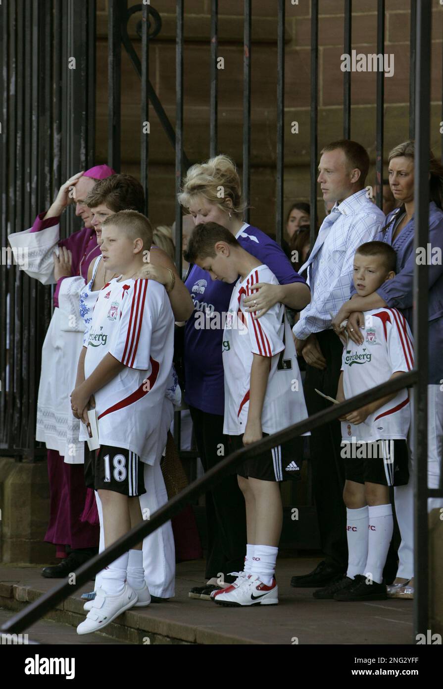Children are comforted by their parents following the funeral of ...