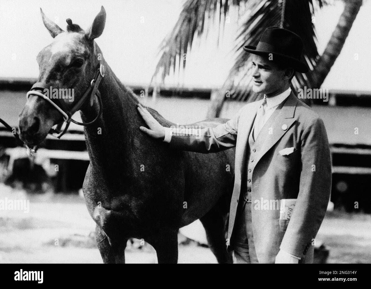 John Hay "Jock" Whitney poses with the brisk filly, New Pin, March 16 ...