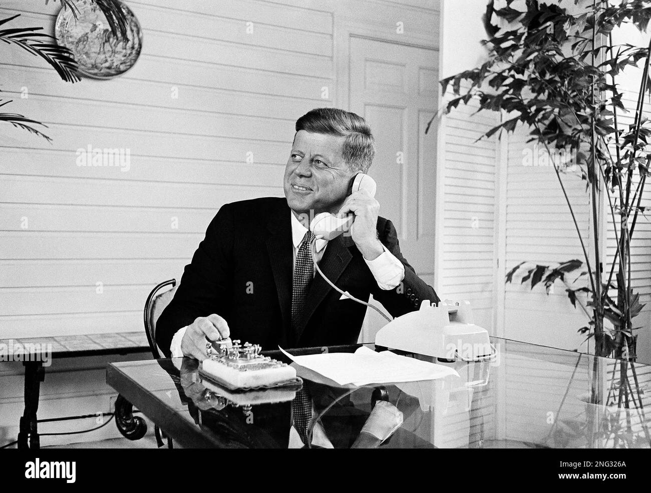 President Kennedy presses a gold telegraph key as he speaks over the ...