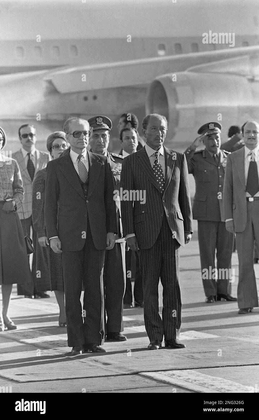 Empress Farah Diba, left, and Shah Mohammad Reza Pahlavi, center, sit ...